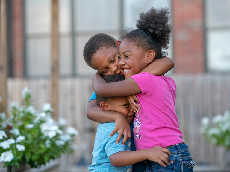 three-children-hugging-each-other-tight - Atlanta Mission
